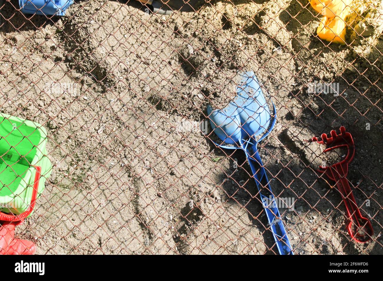 The children's sandbox is closed. Iron mesh over children's toys in the ...
