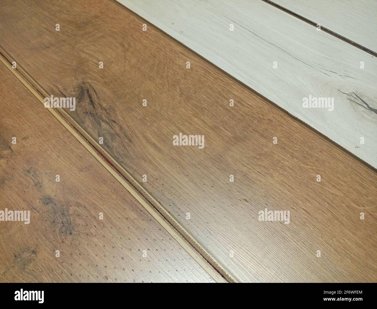 Laminated boards in a package. Floor coverings in packs. Wood texture ...