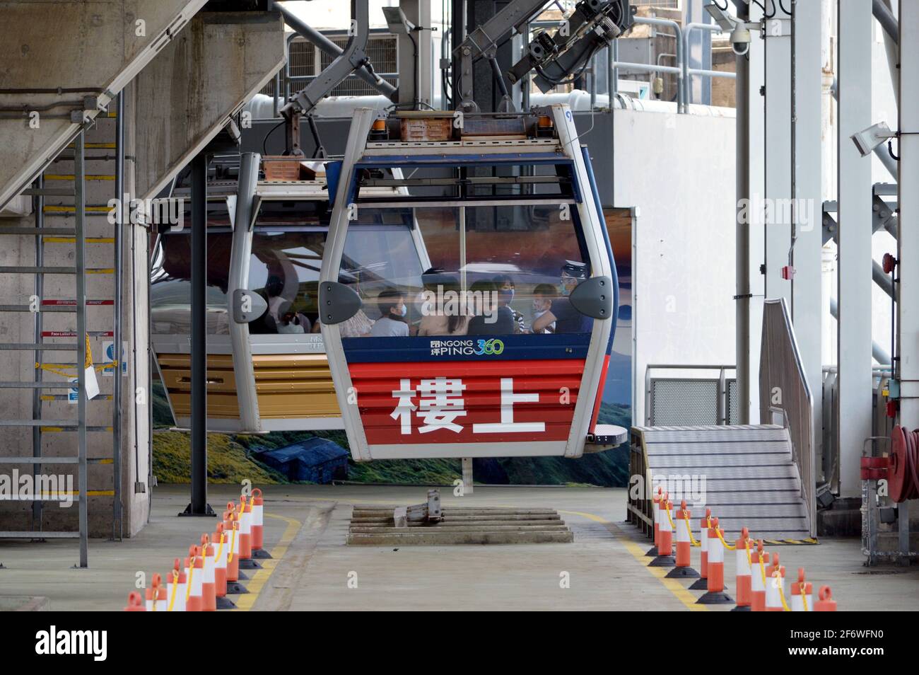 Ngong Ping 360 gondolas passing through Airport Island Angle Station ...
