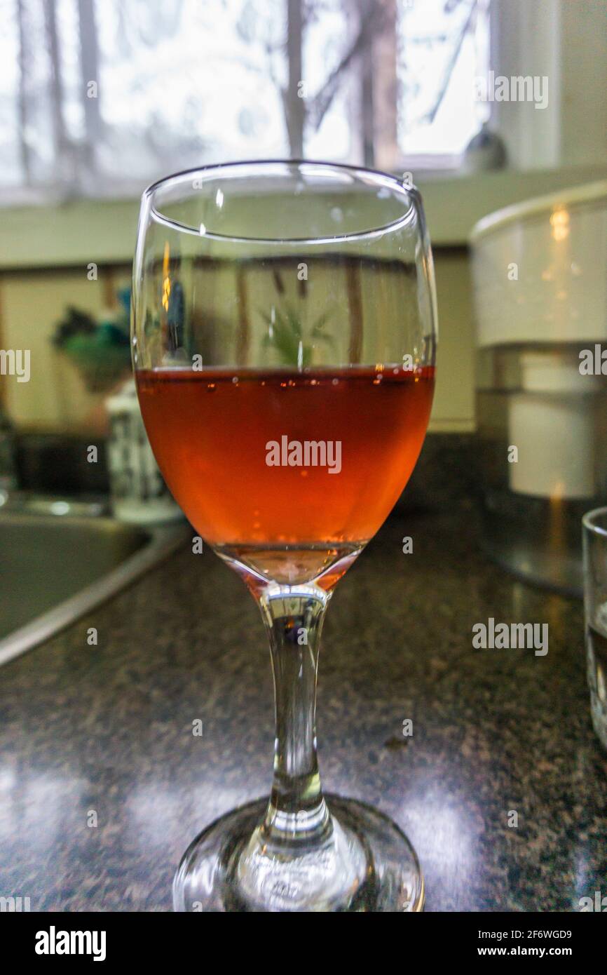 Glass with cool rose wine backlit by window light Stock Photo - Alamy