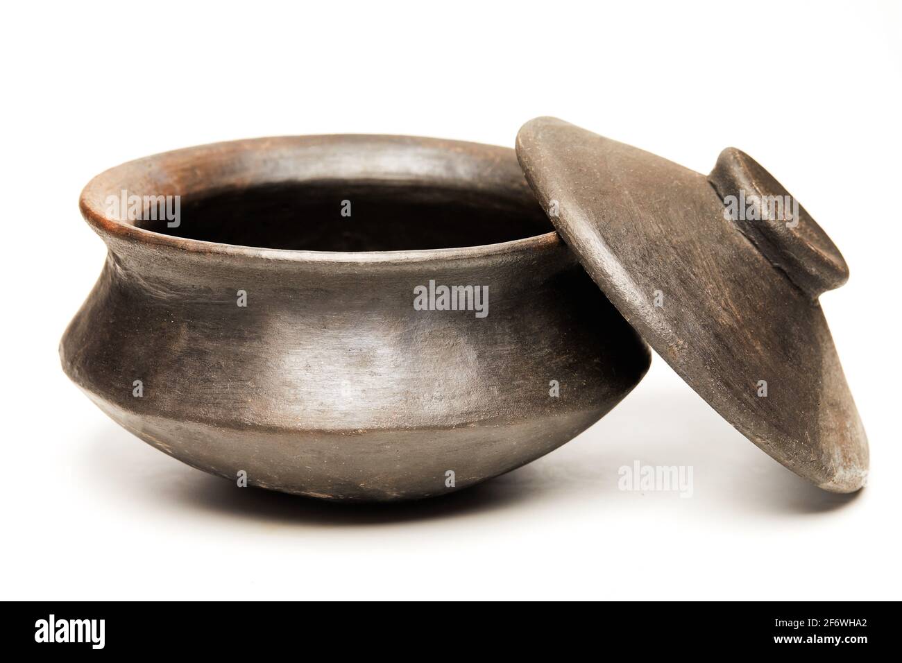 Clay pot with lid made of special black clay for cooking, isolated on a ...