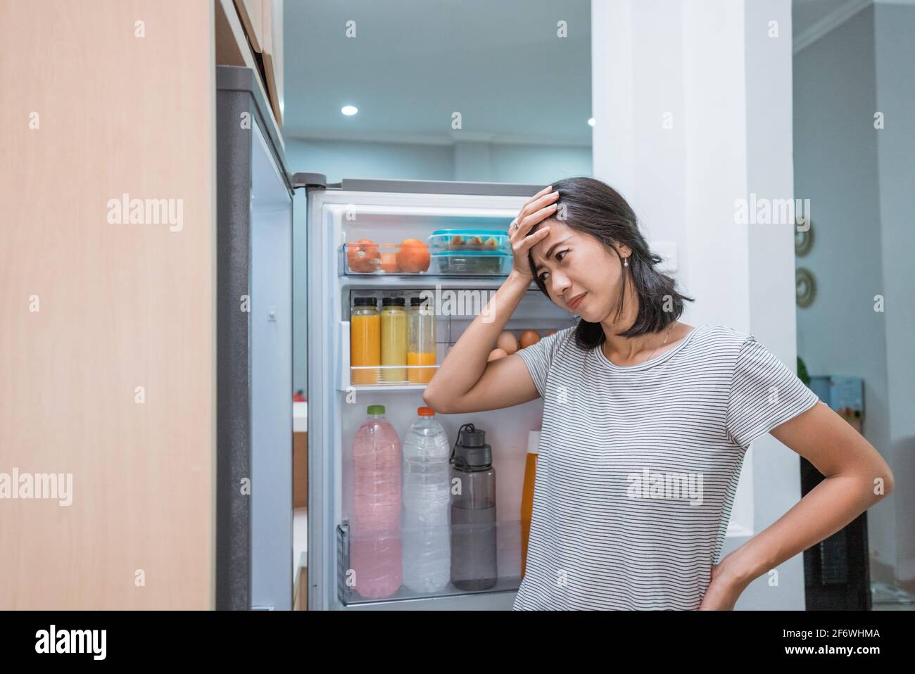 Woman opening fridge door hi-res stock photography and images - Alamy