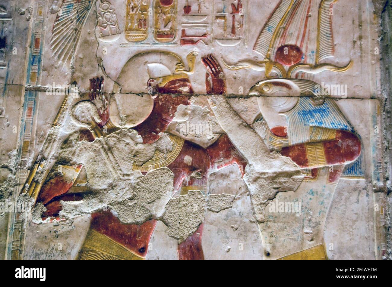A coloured and carved hieroglyph showing the falcon headed god Horus ...