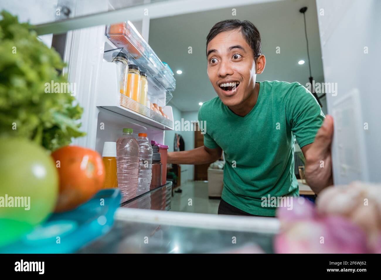 Young man fridge opening hi-res stock photography and images - Alamy
