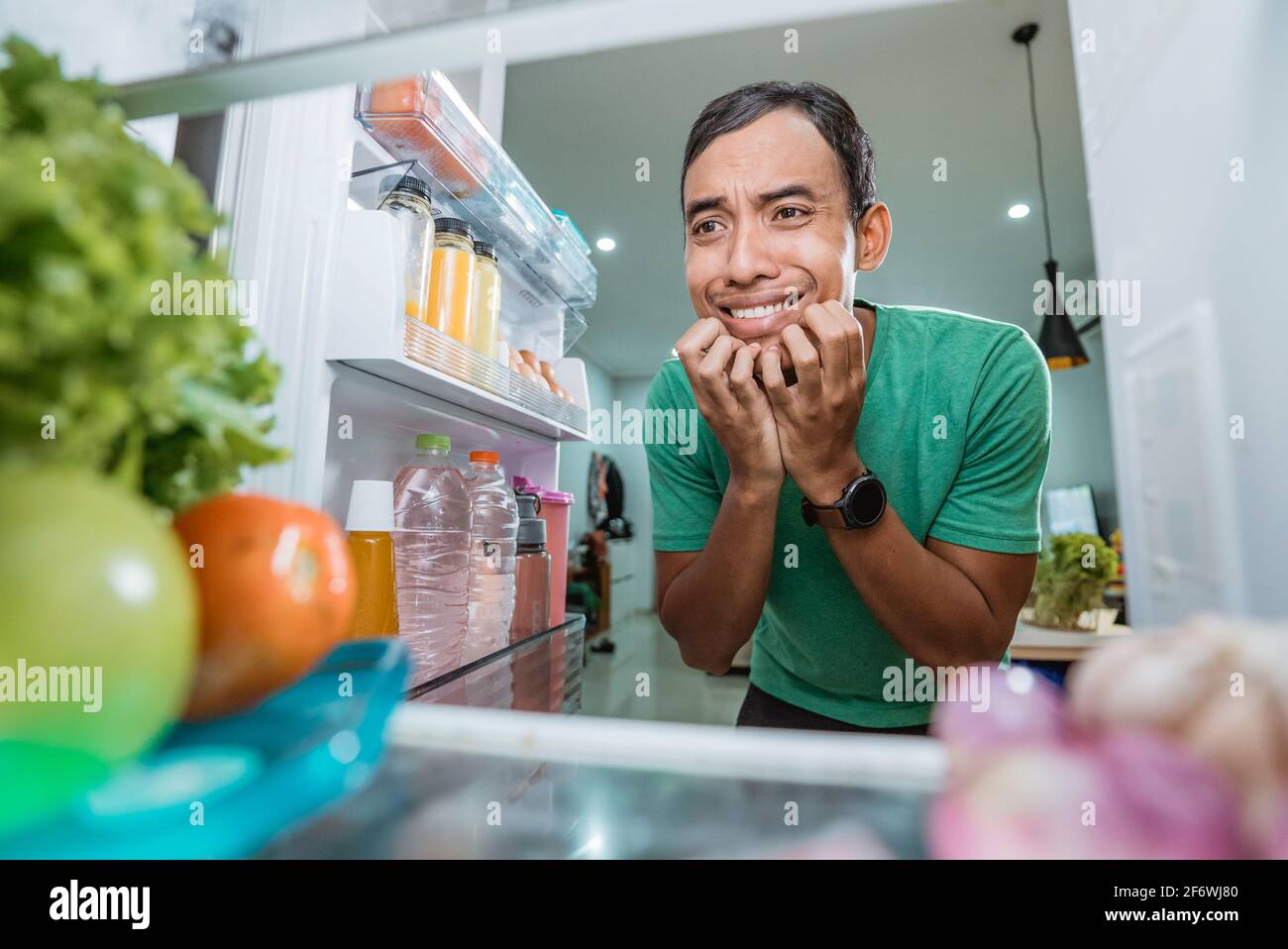 Man looking inside fridge full hi-res stock photography and images - Alamy