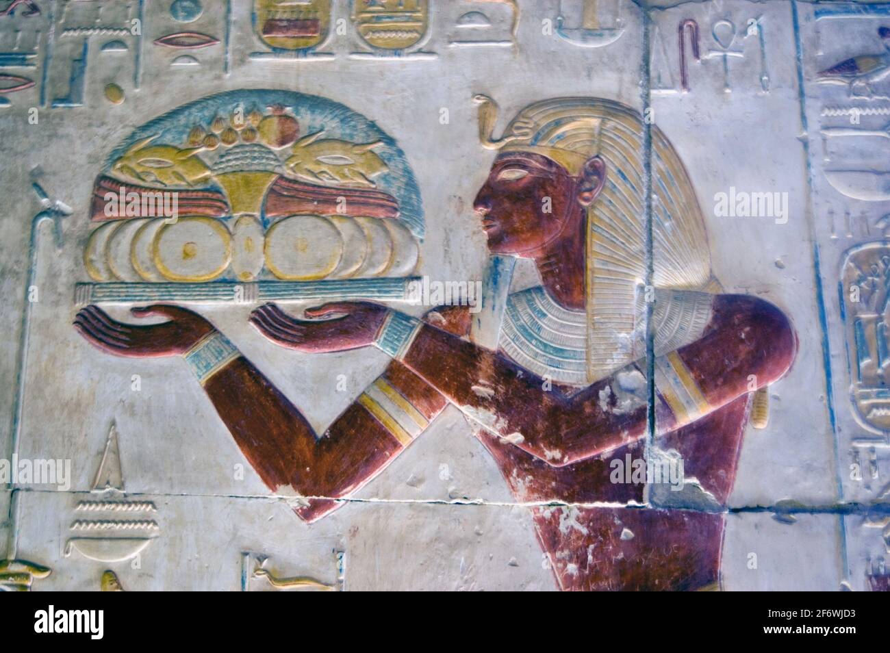 An ancient egyptian hieroglyphic painted carving showing the Pharoah ...