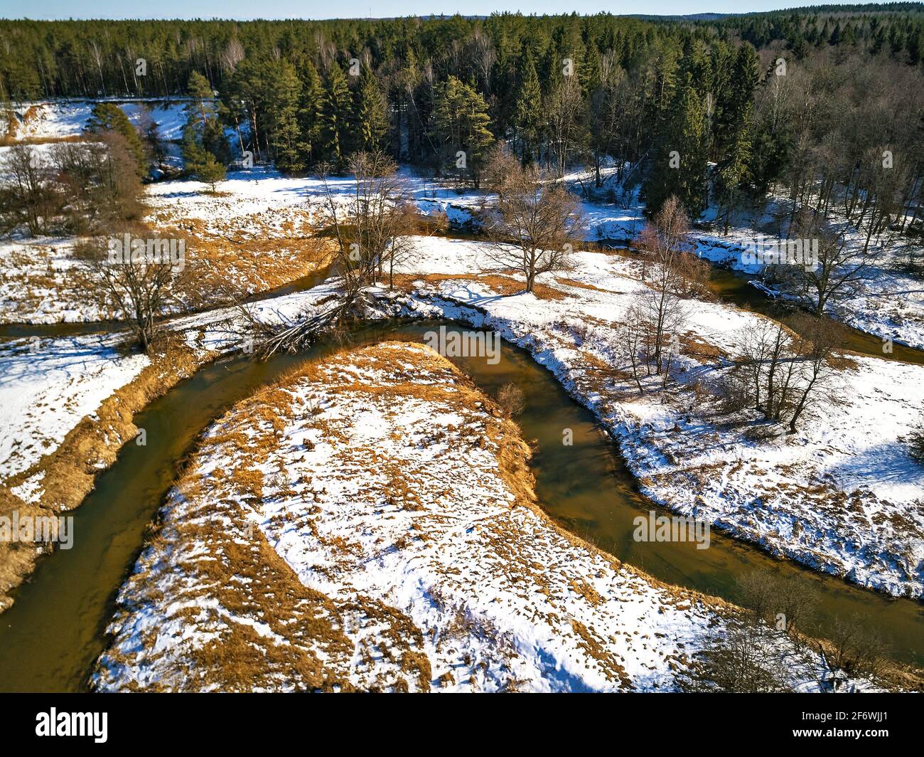 Early spring landscape with melting snow and thawed patches in meadow ...