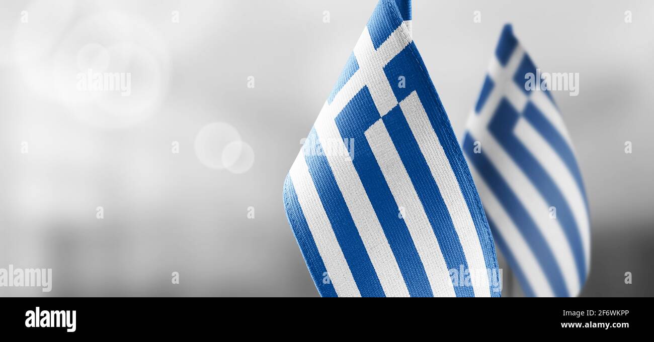 Small national flags of the Greece on a light blurry background Stock ...