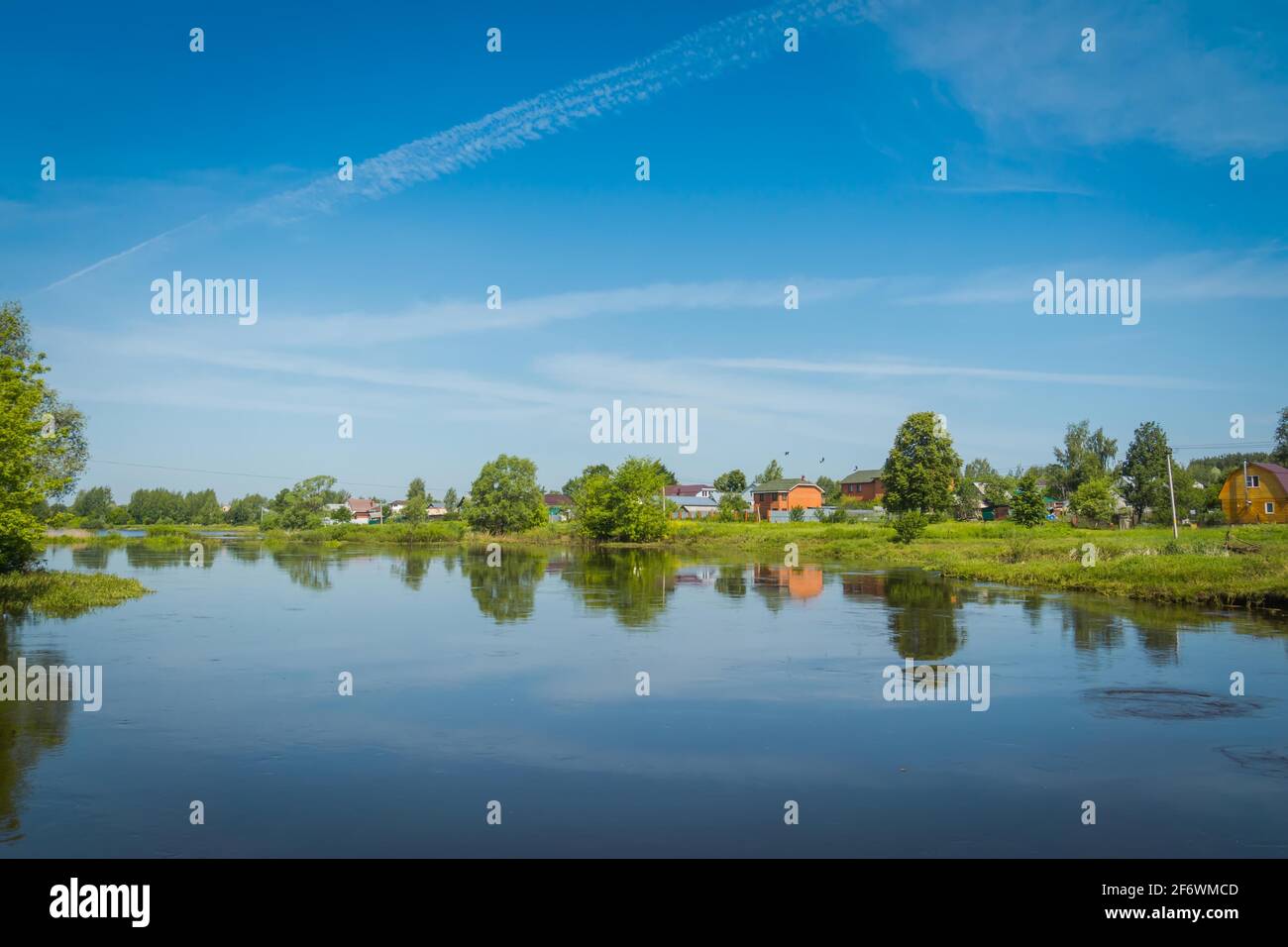 Summer rural landscape with river and blue sky background Stock Photo ...