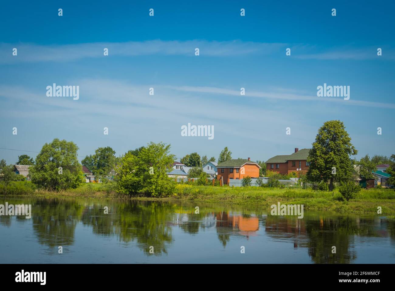 Summer rural landscape with river and blue sky background Stock Photo ...