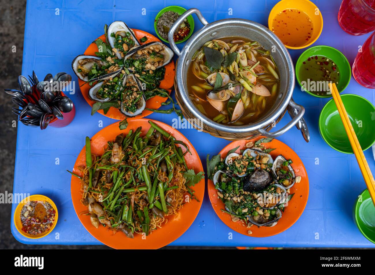 Vietnamese street food at night market - grilled mussels and clams ...