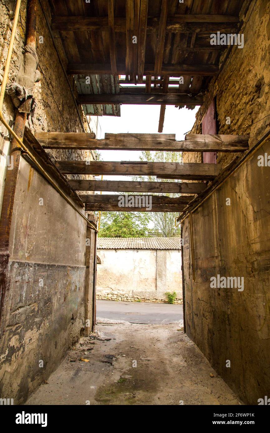 Image of a passage between old dilapidated houses Stock Photo - Alamy