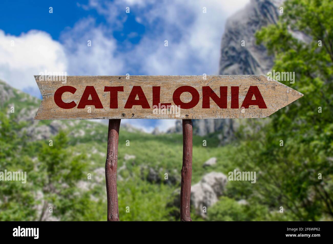 Catalonia wooden arrow road sign against mountain valley background ...