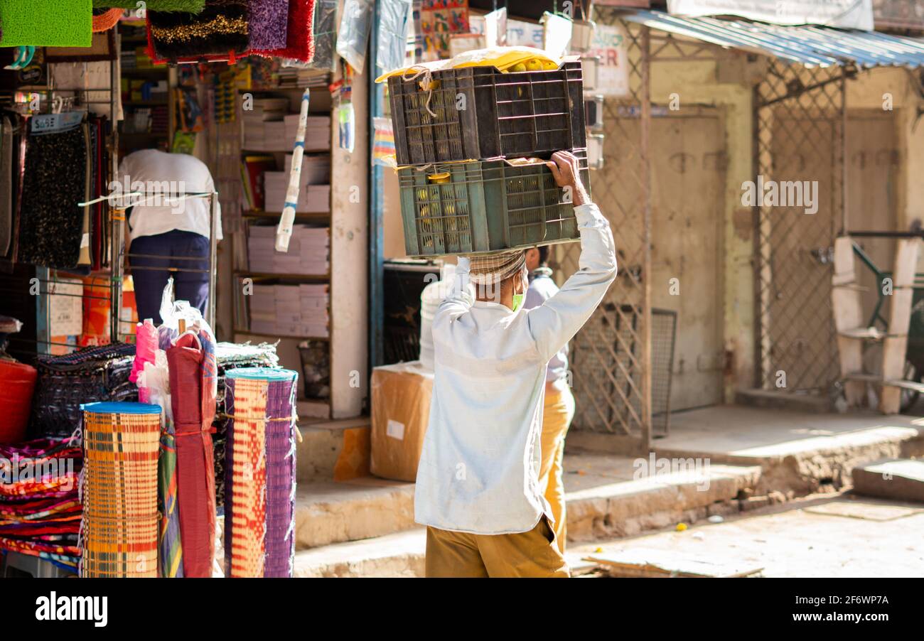 K.R.Market, Bangalore, India - February 06,2021:Labour carrying two ...