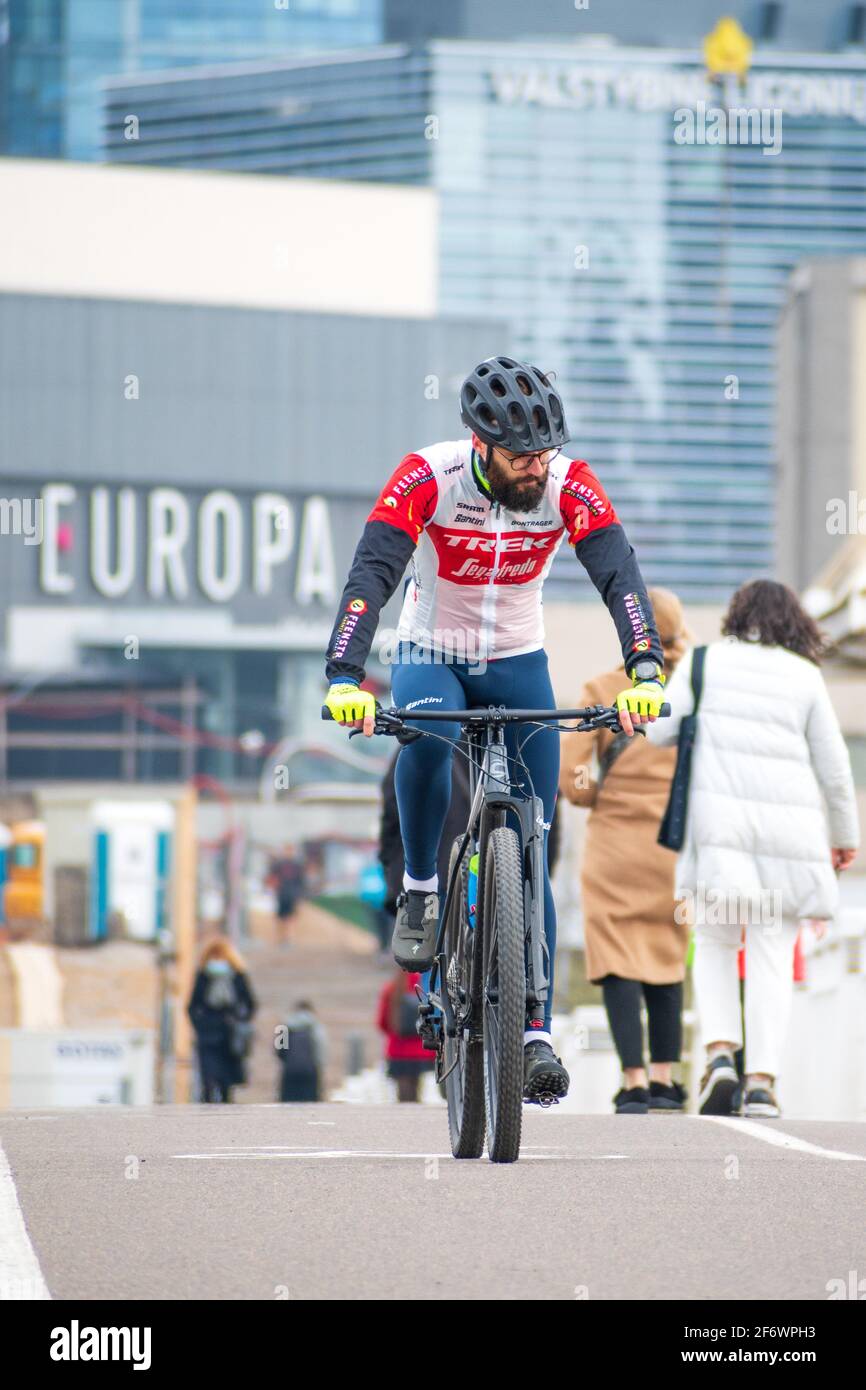 Rider, man or boy with helmet cycling on the road bike in the city ...