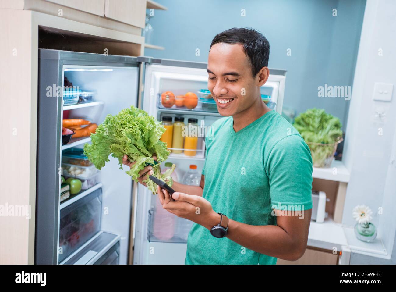 Man standing front fridge hi-res stock photography and images - Alamy