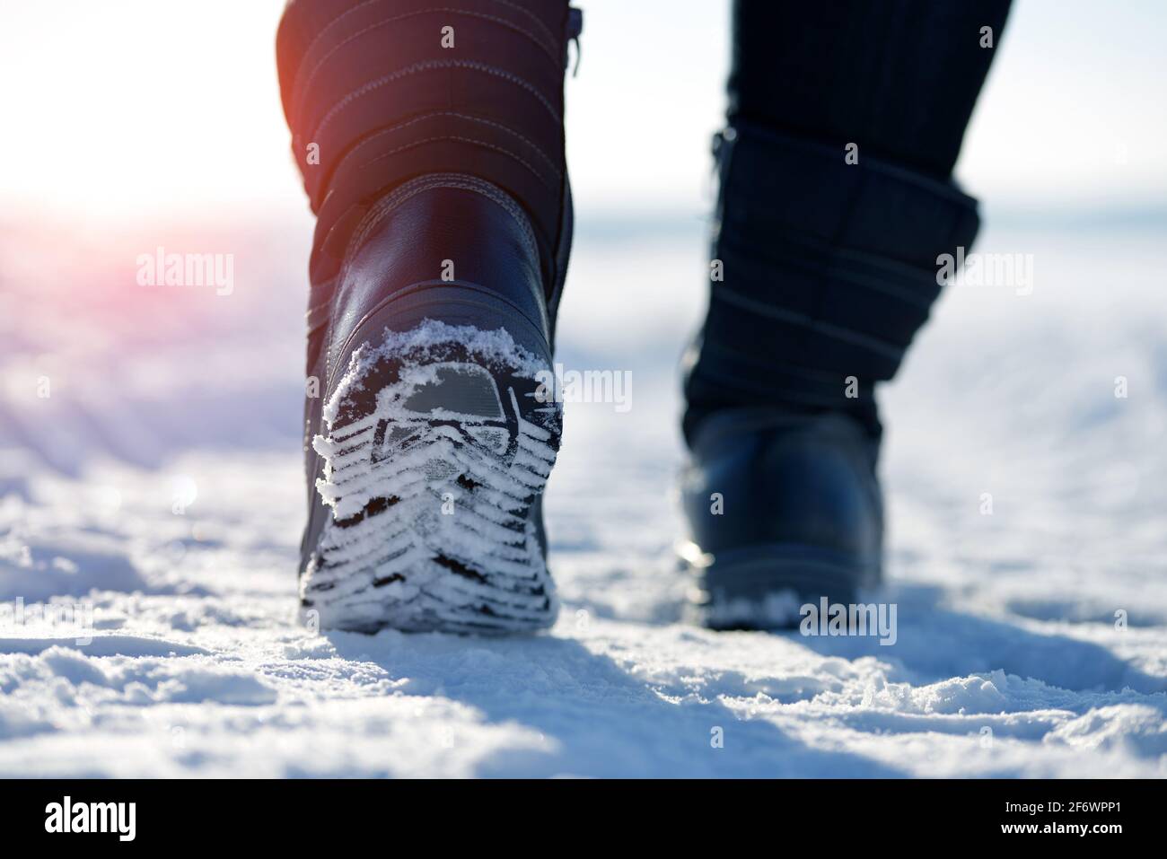 Female feet in winter boots, walking in the snow Stock Photo - Alamy