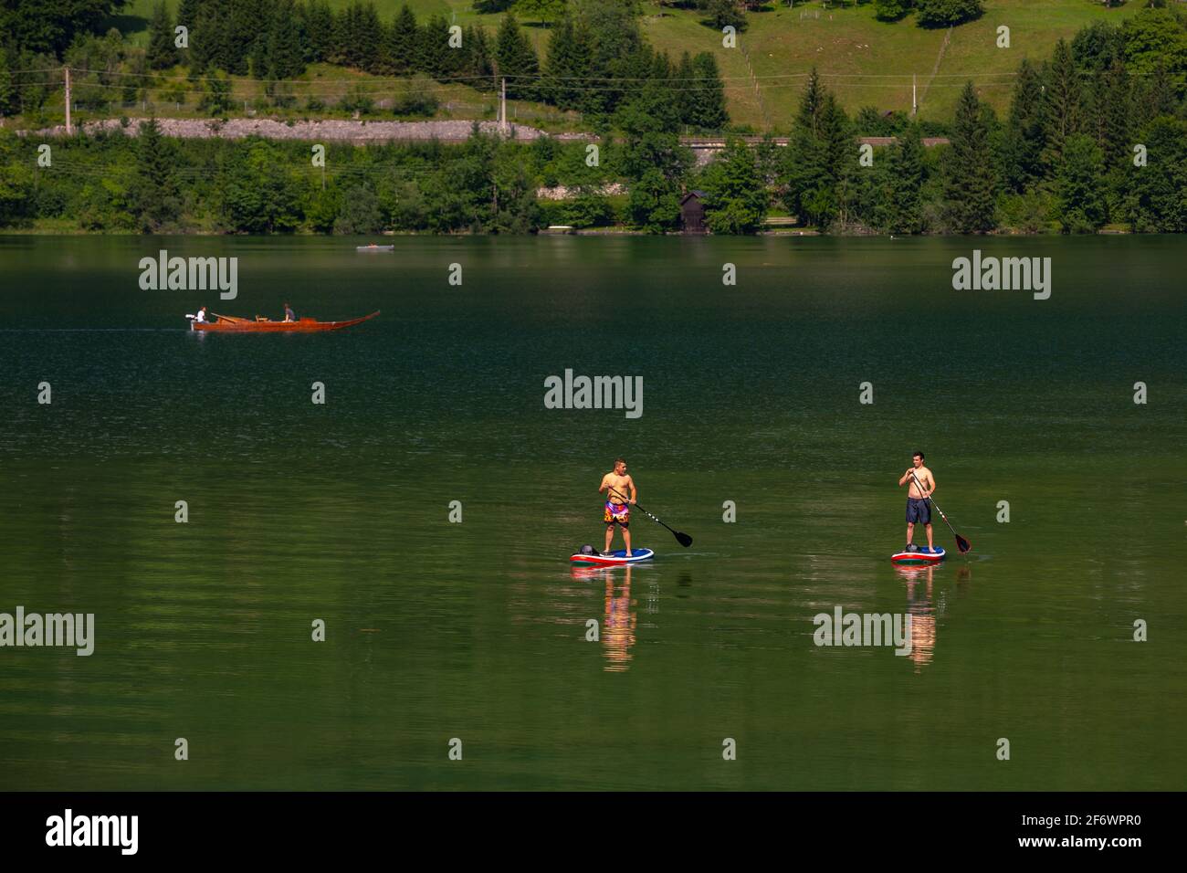 Two young men on the inflatable paddle board on Hallstätter See or Lake ...
