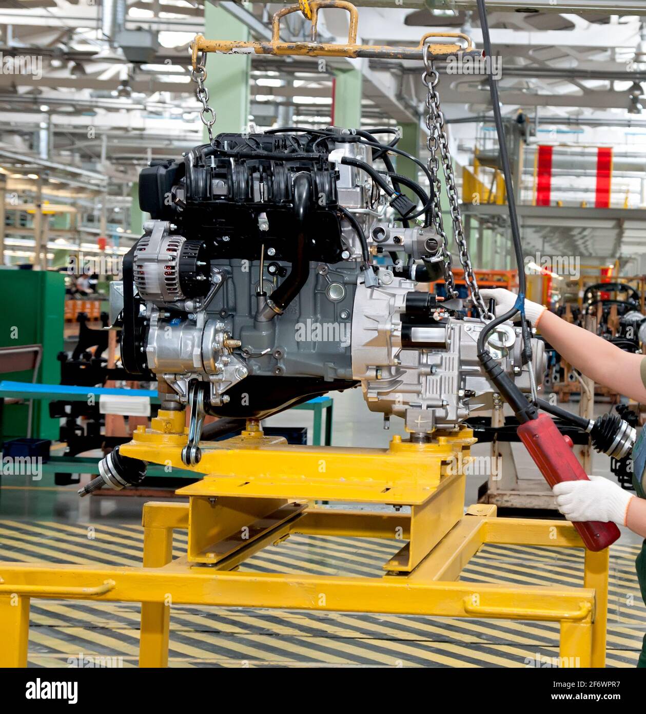 Transportation of the new car engine valve on a car repair factory ...