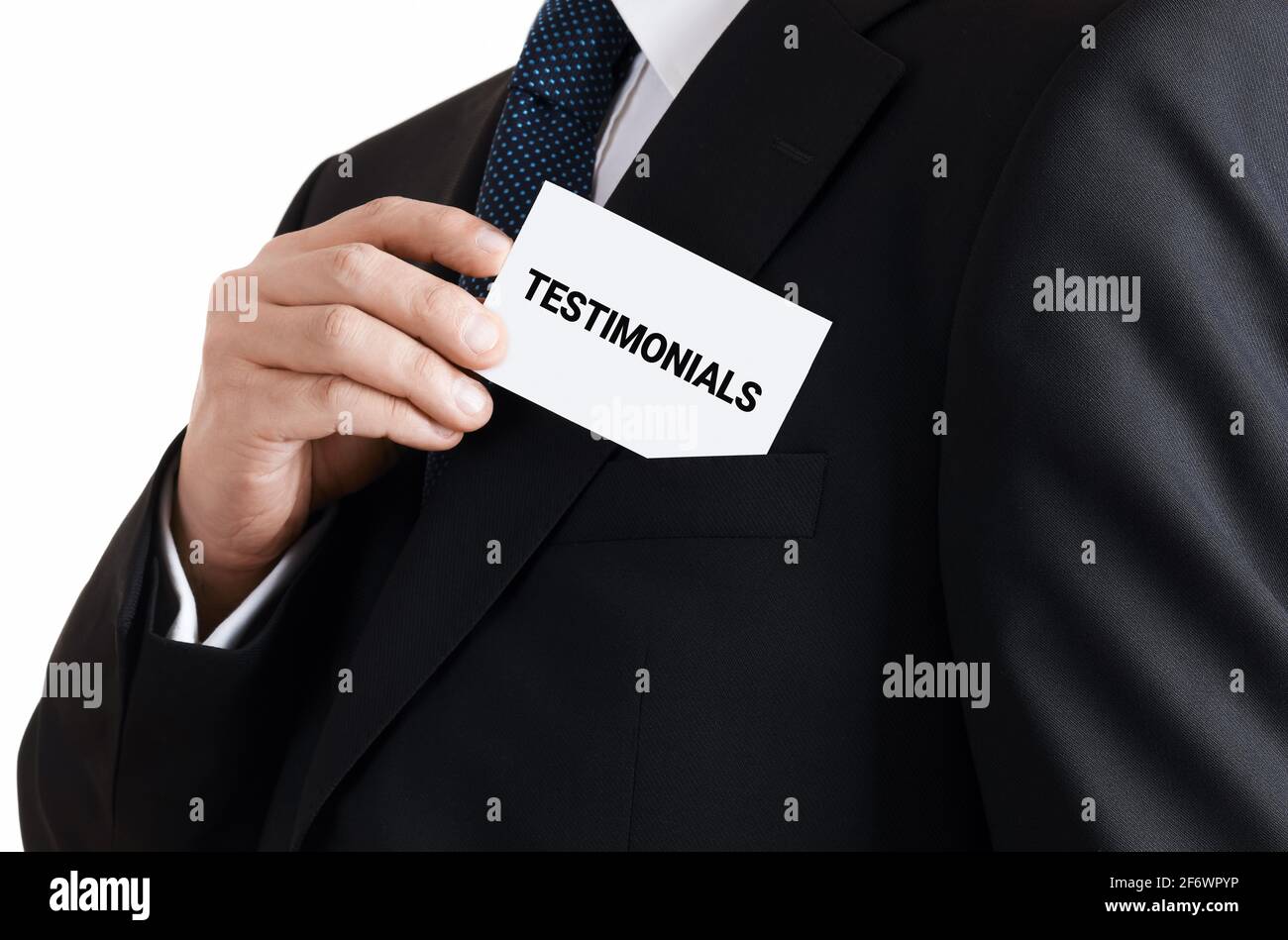 Businessman takes out a business card with the word testimonials ...