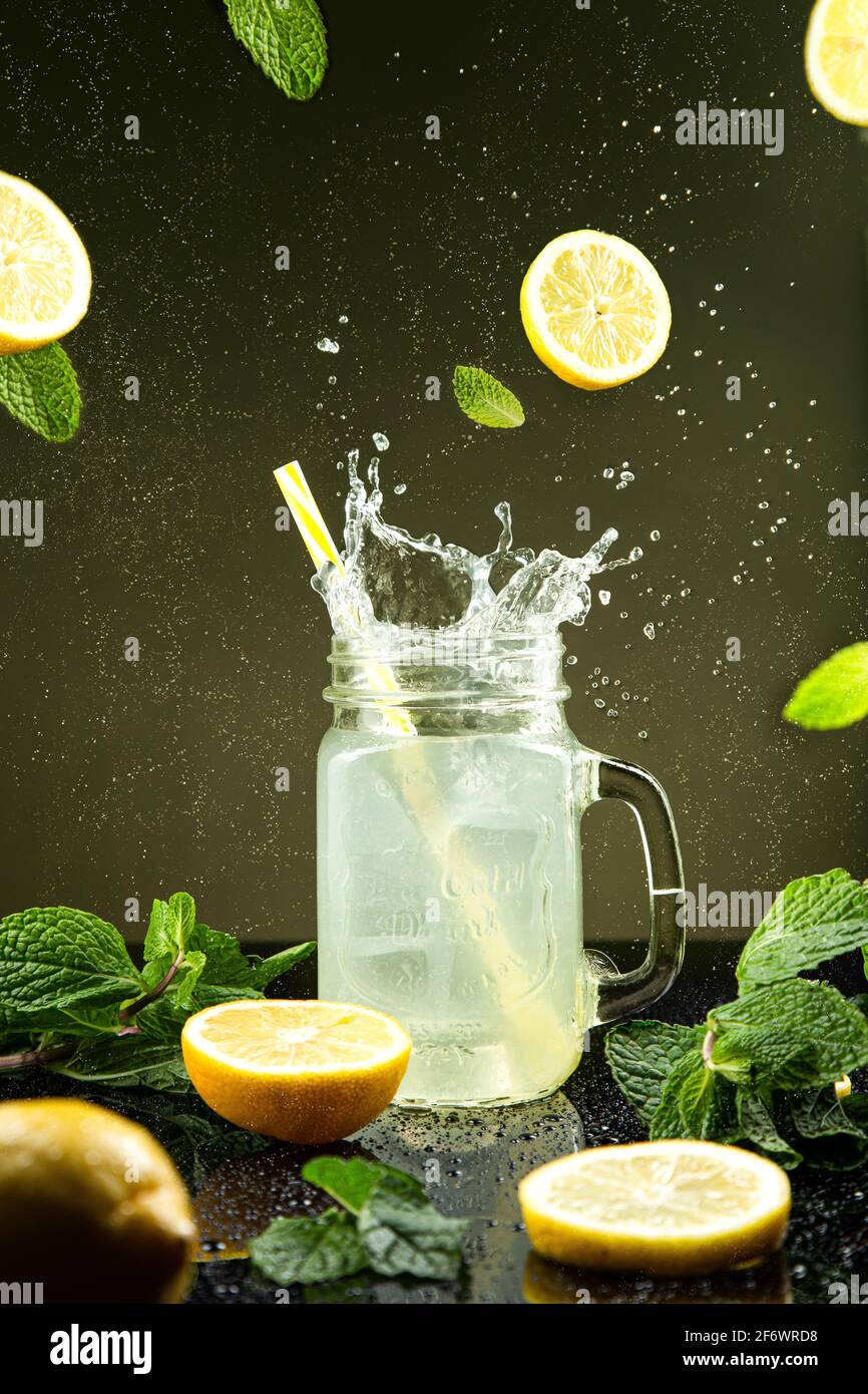 Lemonade splash on dark background Stock Photo - Alamy