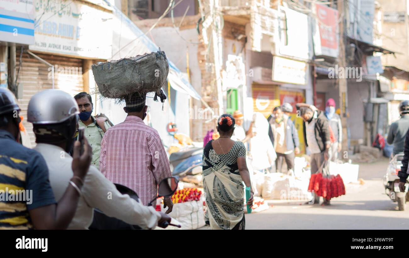 K.R.Market, Bangalore, India - February 06,2021: A labour carrying the ...
