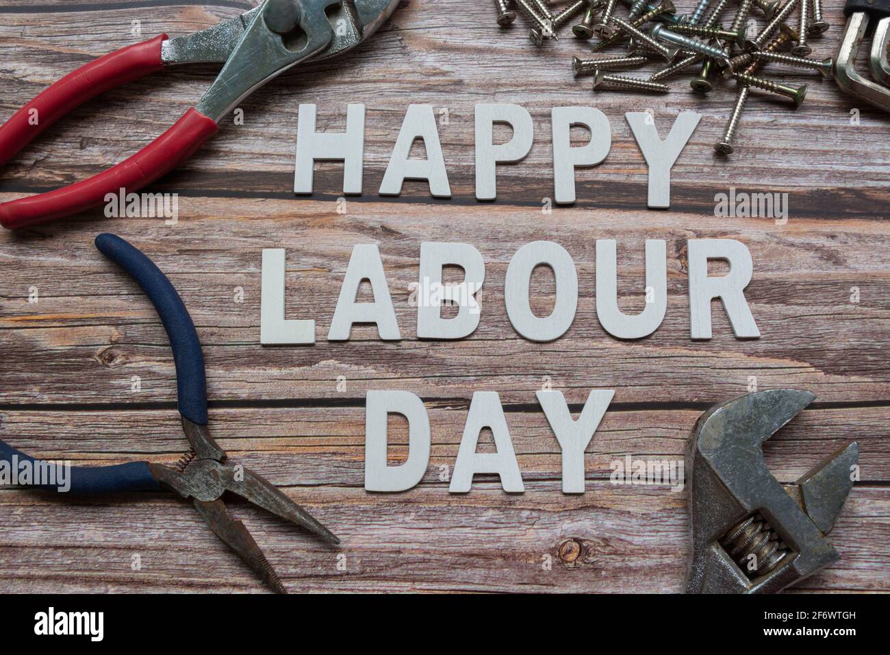 Happy labor day text with many handy tools on wooden background Stock ...