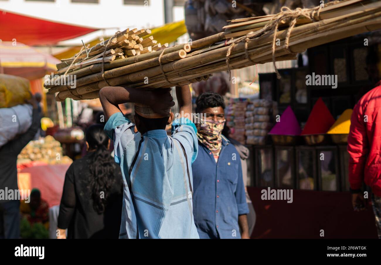 K.R.Market, Bangalore, India - February 06,2021: A labour carrying the ...