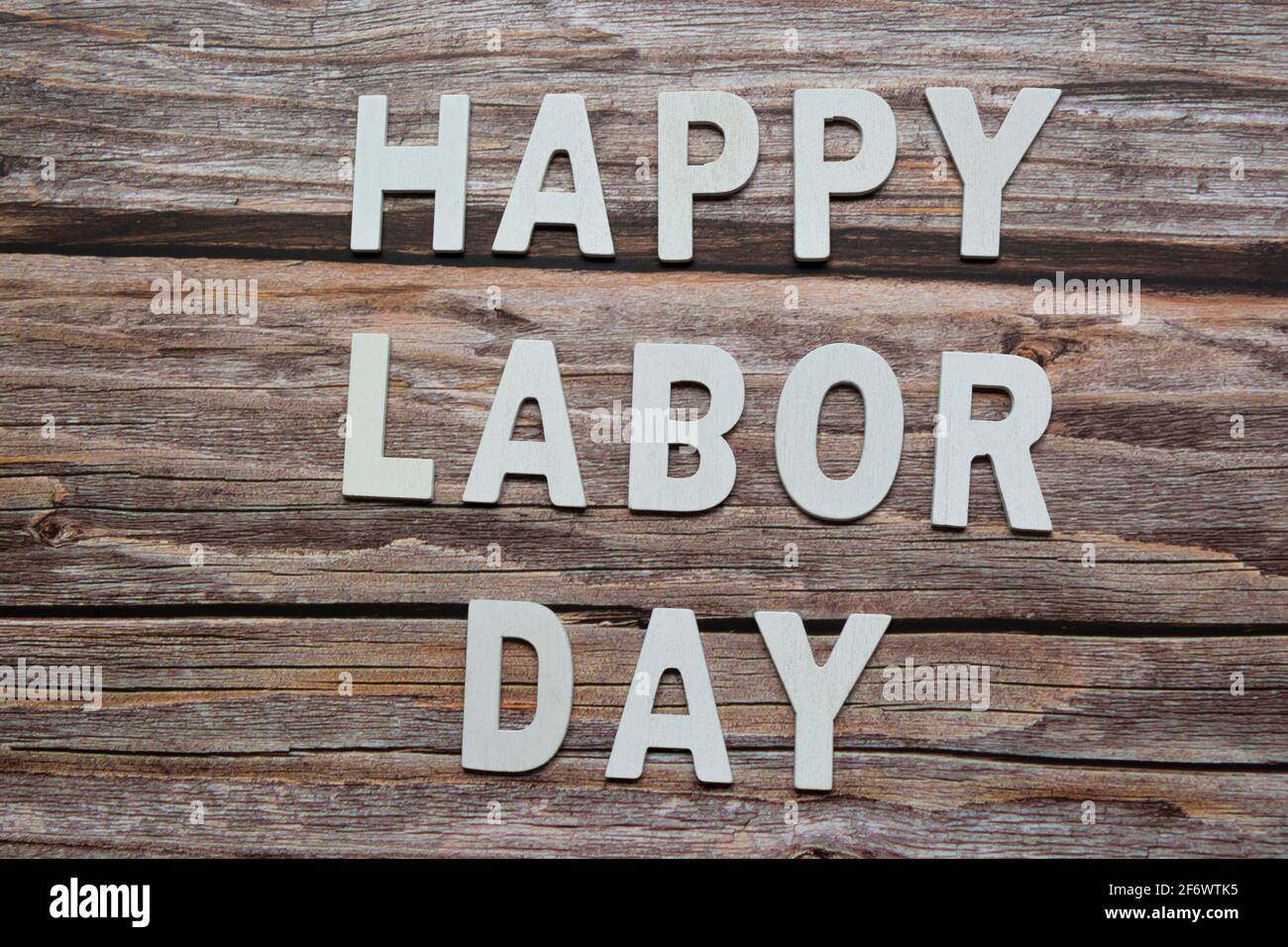Happy labor day text on wooden table background. Labor day concept ...