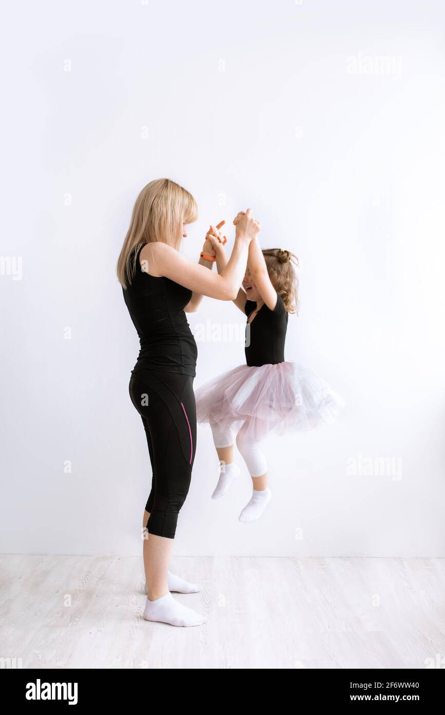 Happy family mom and daughter having dancing at home together. Support ...