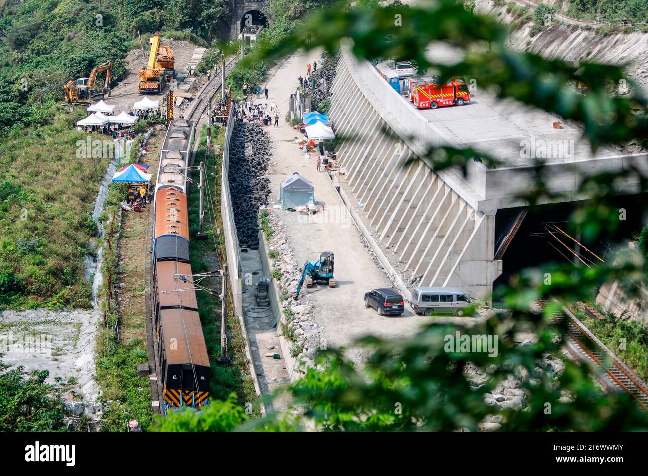 An overview of the damaged train carriage is lifted and removed from a ...