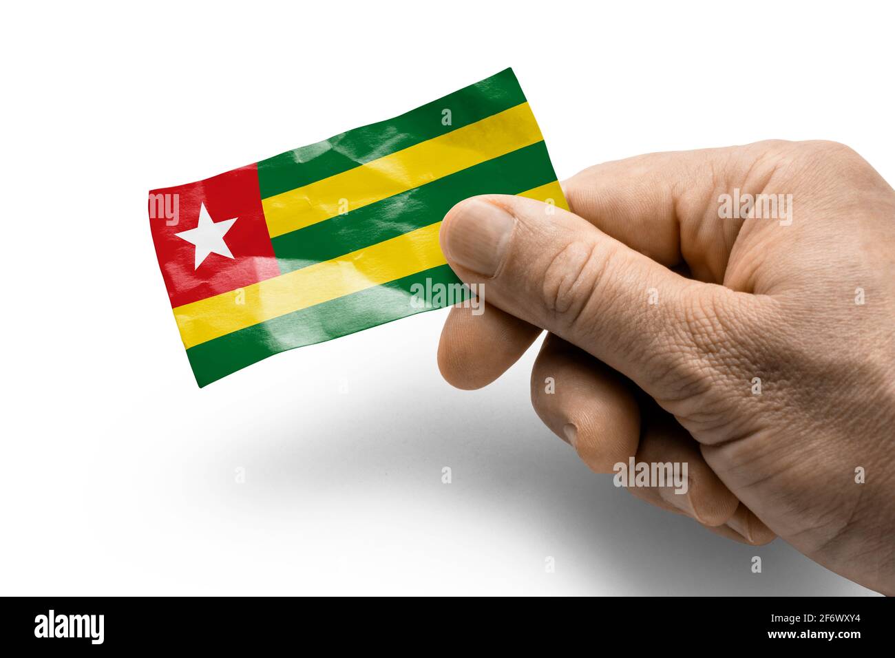 Hand holding a card with a national flag the Togo Stock Photo - Alamy