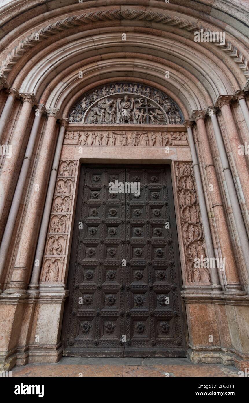 The great, imposing door of the Baptistry, set in an ornately carved ...