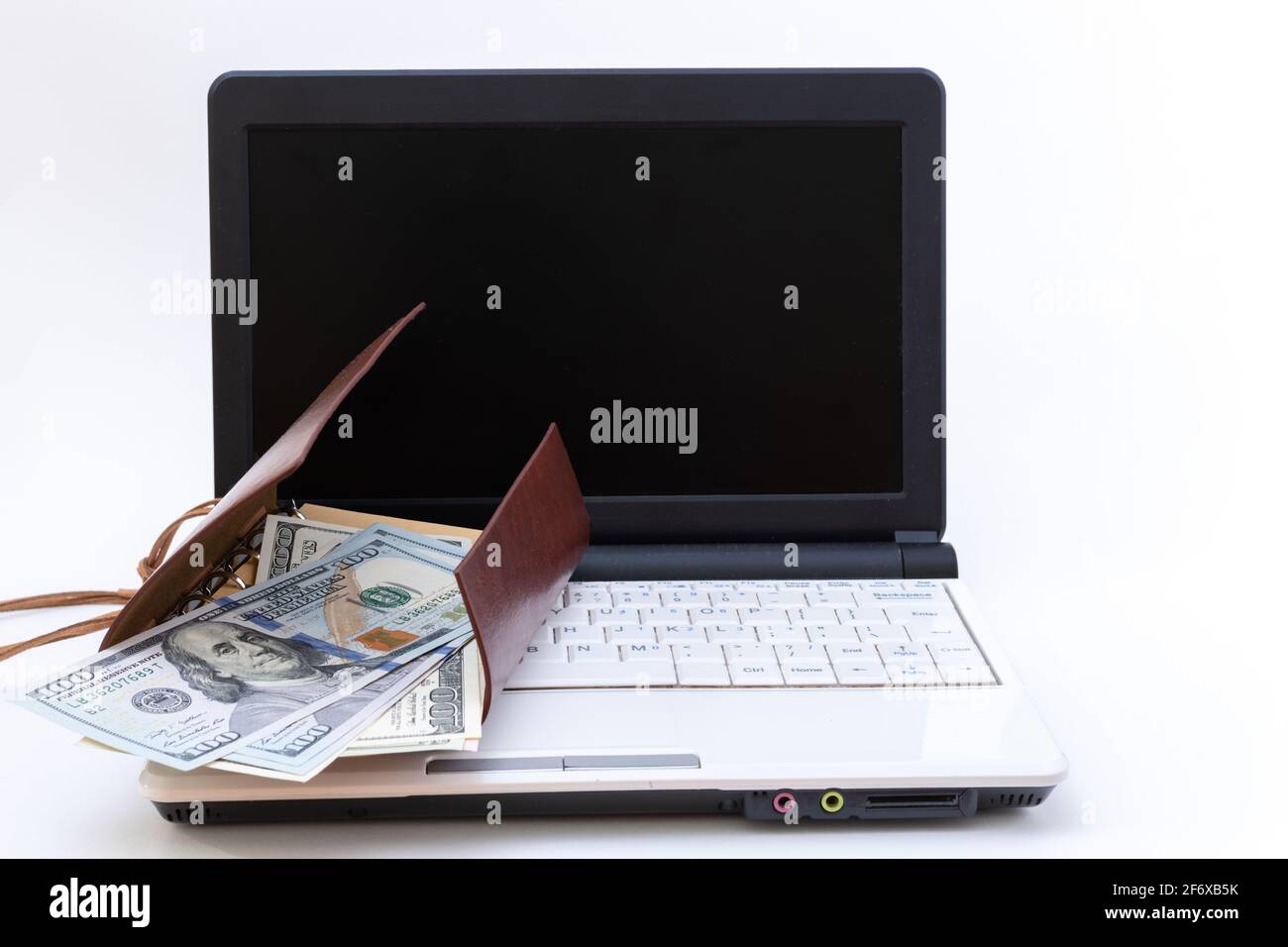 Laptop with blank black screen, open wallet with US dollars on a white ...