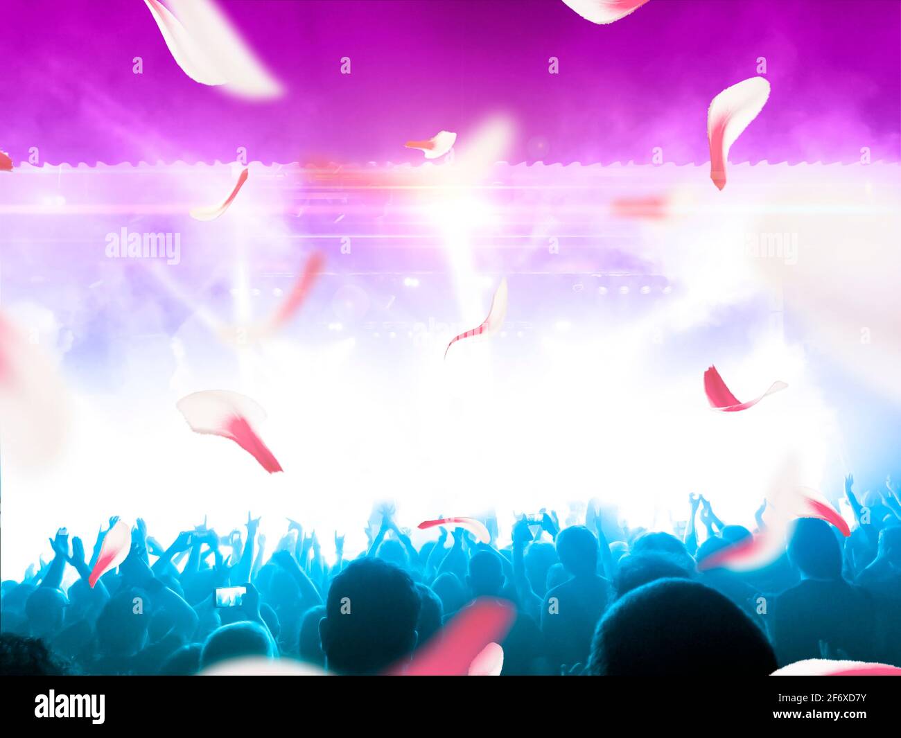 Large gathering of people in front of a lit stage Stock Photo - Alamy