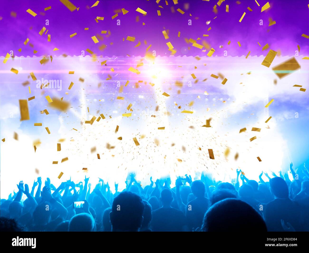 Large gathering of people in front of a lit stage Stock Photo - Alamy