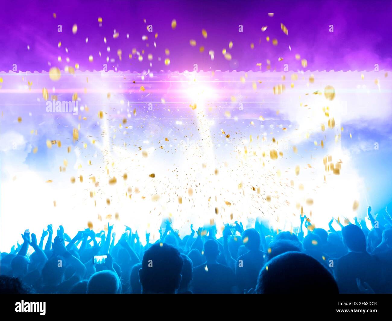 Large gathering of people in front of a lit stage Stock Photo - Alamy