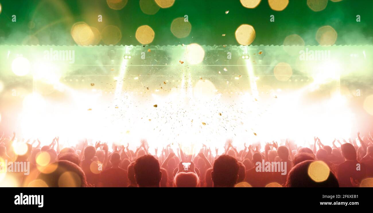 Large gathering of people in front of a lit stage Stock Photo - Alamy