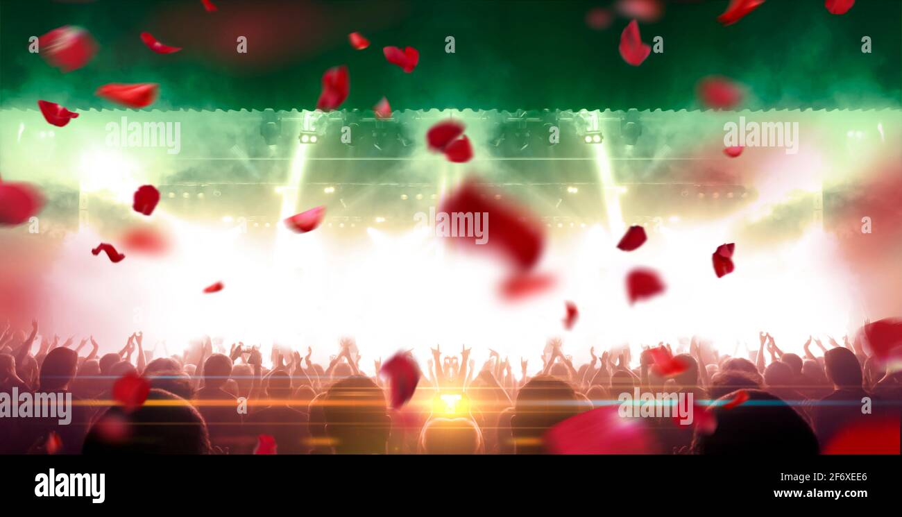 Large gathering of people in front of a lit stage Stock Photo - Alamy