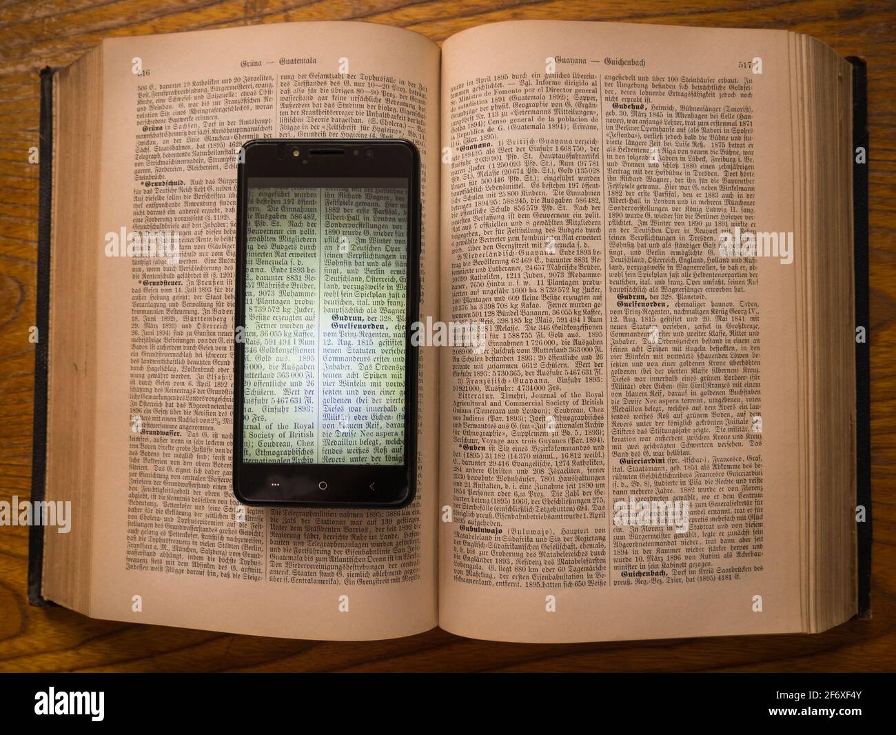 Smart phone with a digital copy of more than 100 years old book lies on ...