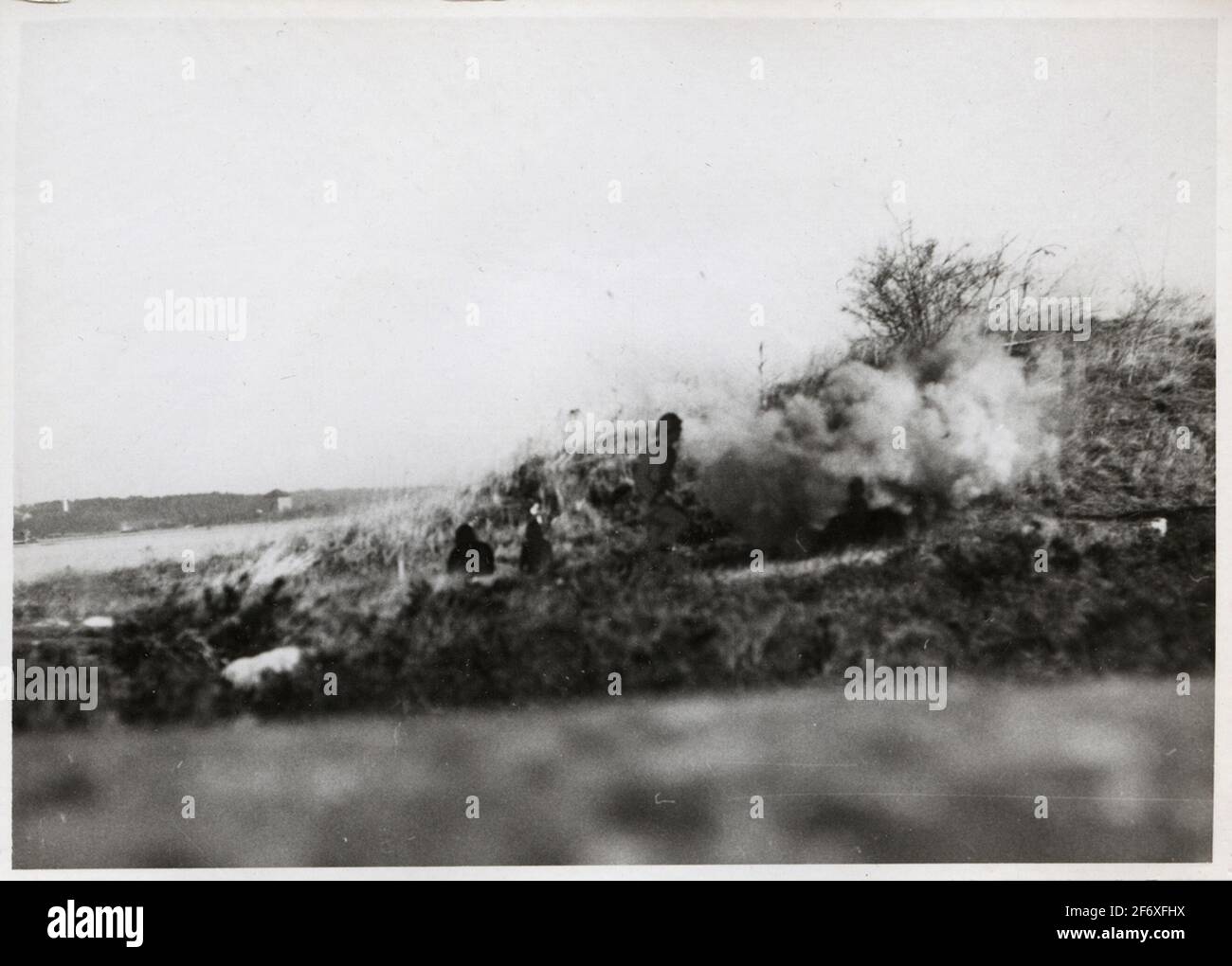 Explosion on hill 2 men Stock Photo - Alamy