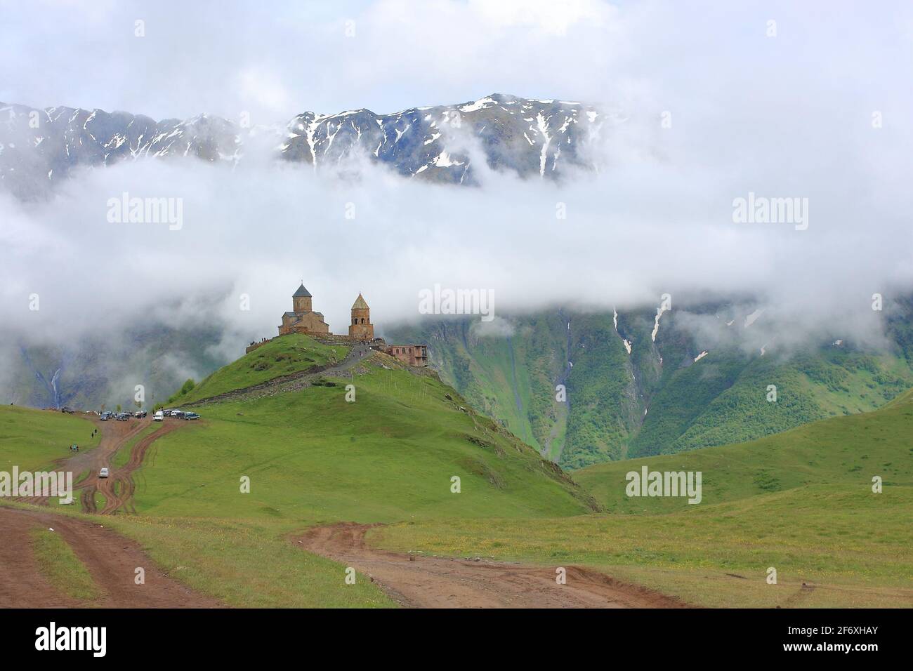 The Holy Gergeti Trinity Church in clouds in Georgia, the Caucasus with ...