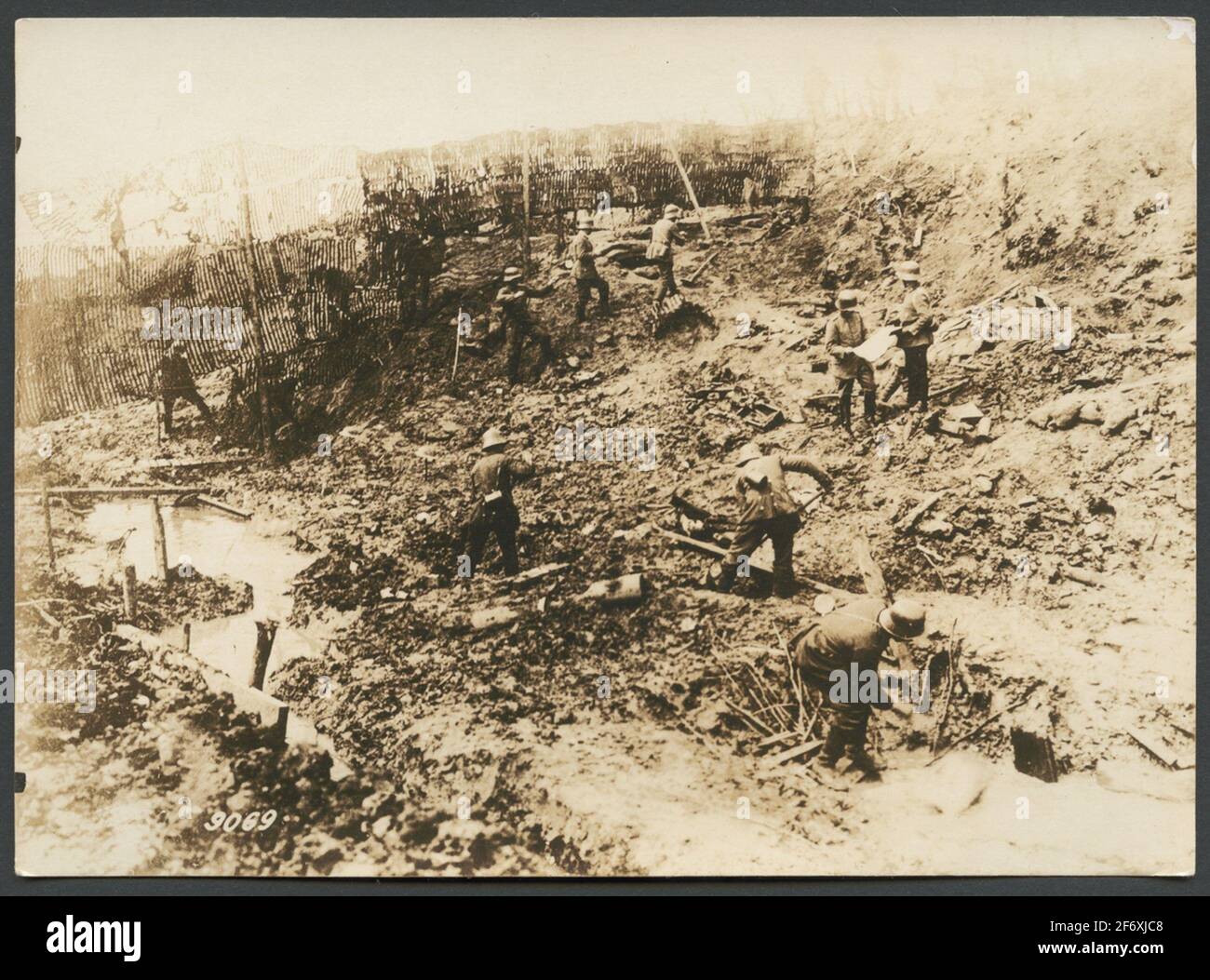 The picture shows a group of soldiers with shovels that dig in the ...