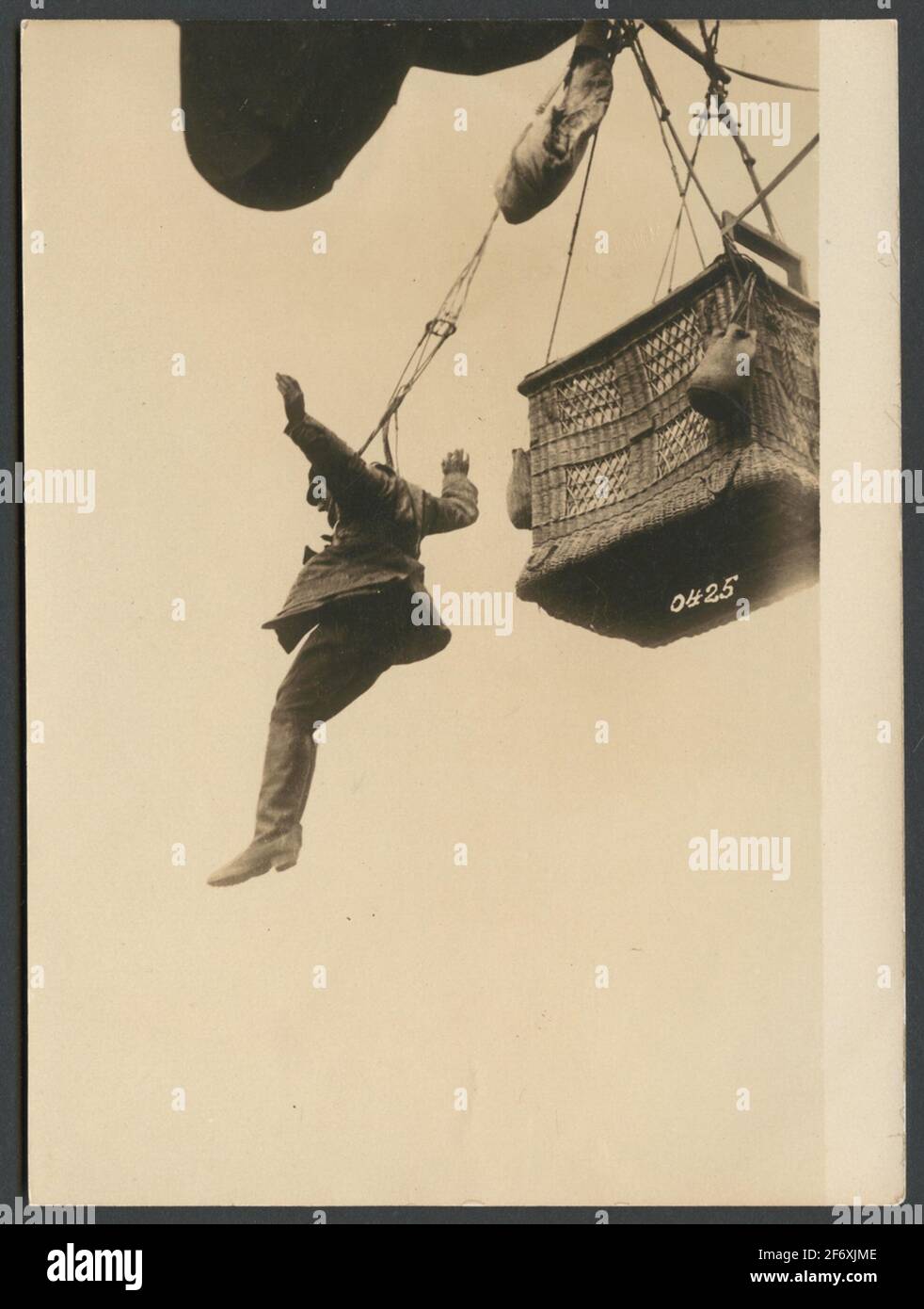 The picture shows a soldiers jumping from a balloon basket using a ...