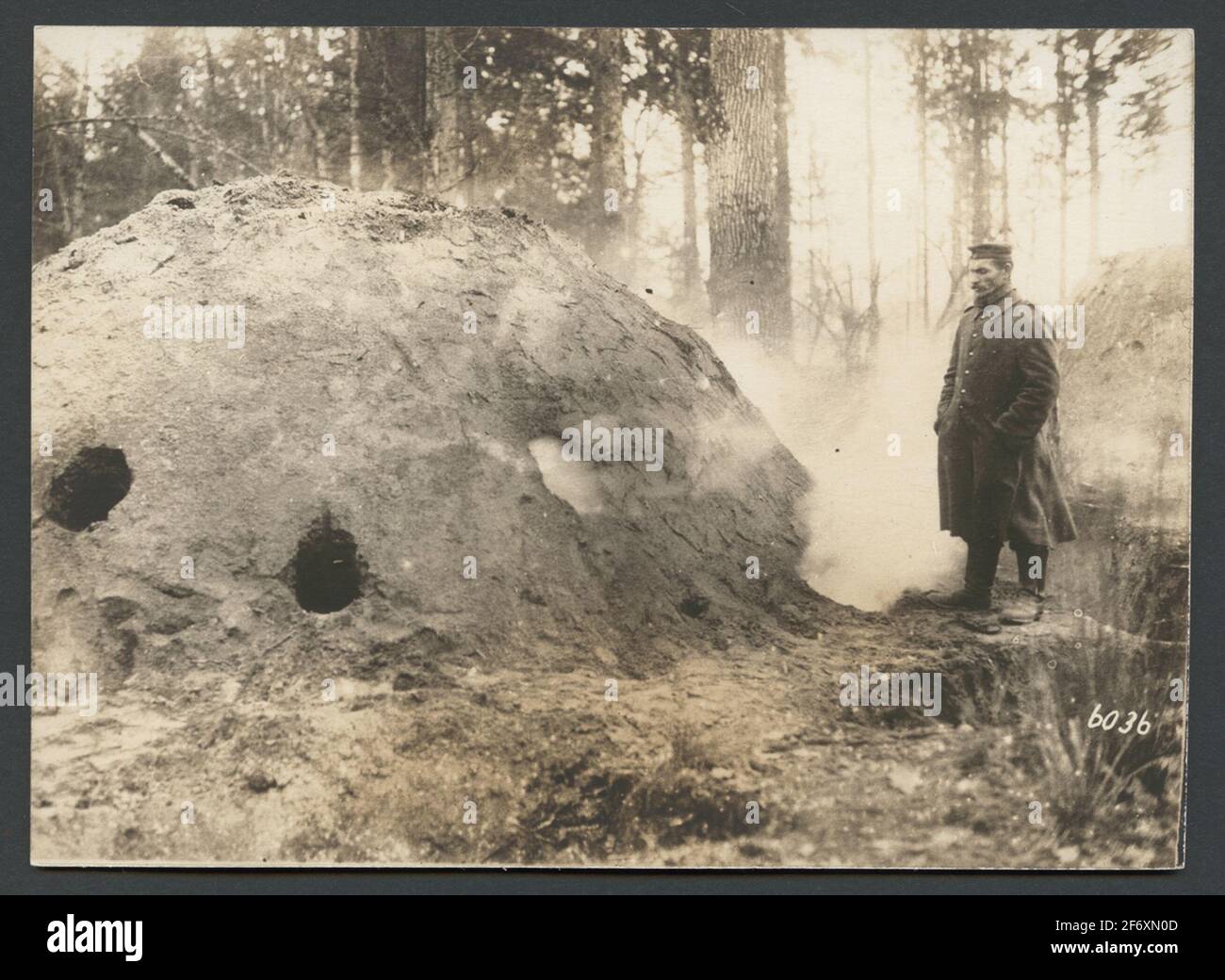 The picture shows a soldier who looks at a smoking kolmila .. The ...