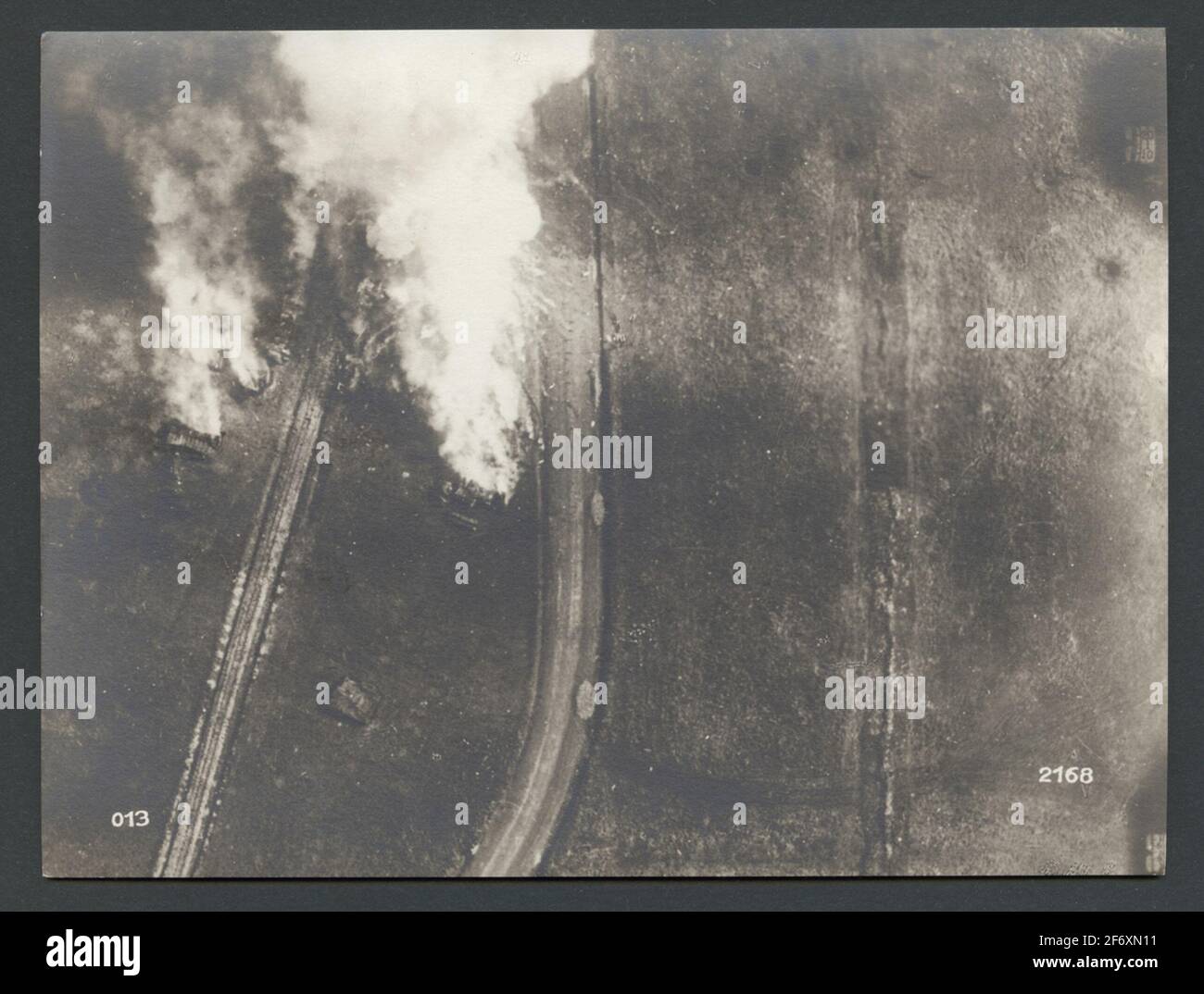 This flight image shows burning objects and smoke clouds between a rail ...