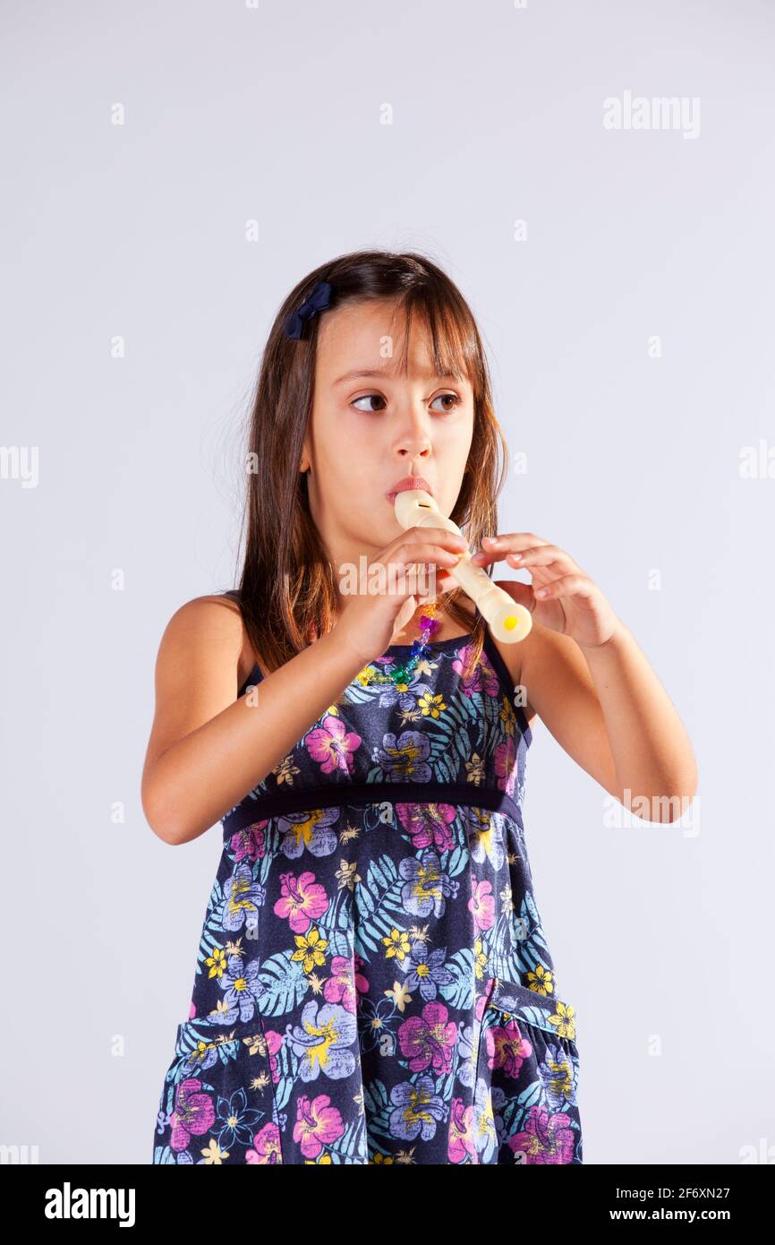 Little girl playing music with a flute Stock Photo - Alamy