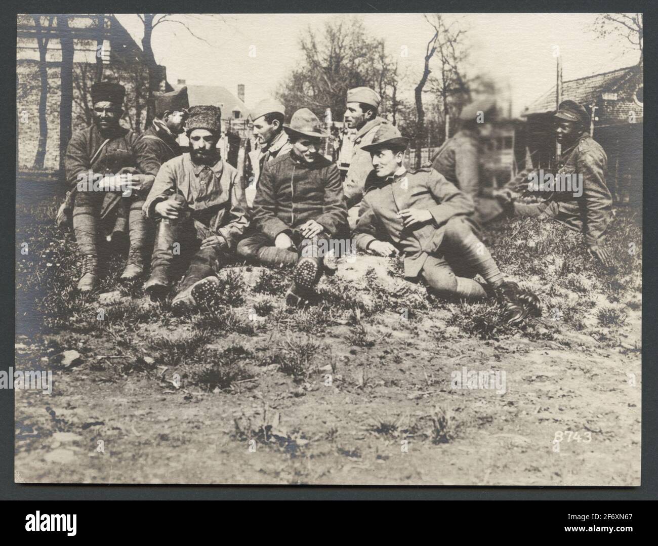 The picture shows captured allied soldiers sitting on the ground and ...
