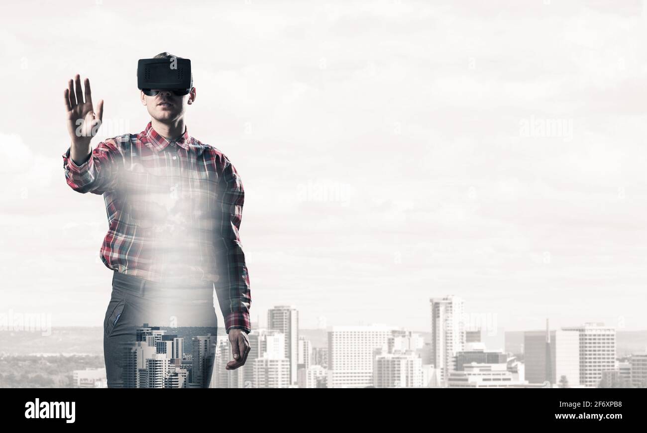 Guy wearing checked shirt and virtual mask stretching hand to touch ...