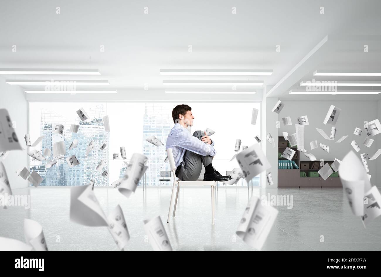 scared businessman on a chair in office Stock Photo - Alamy